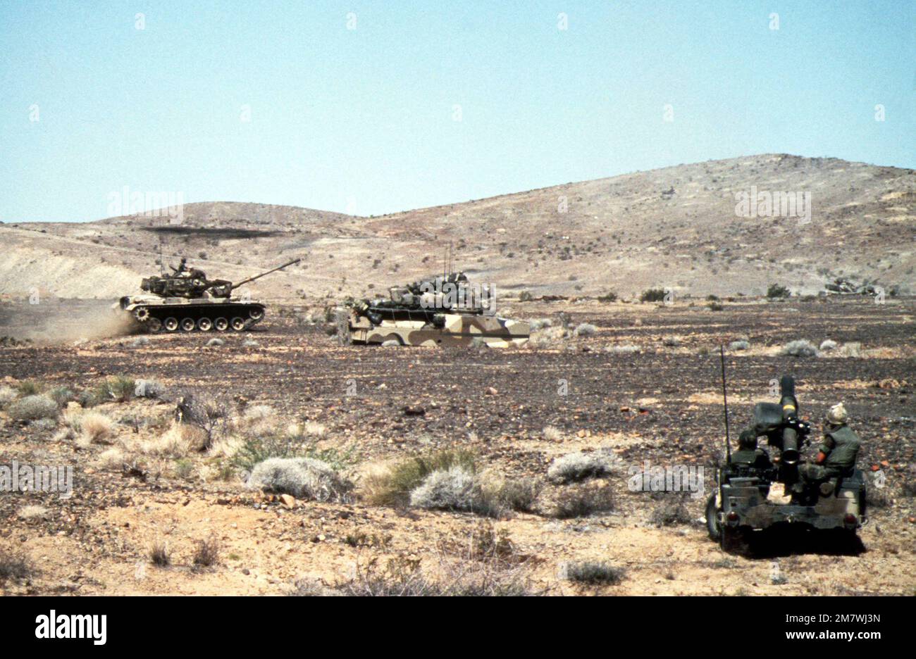 A right side view of an M-60 main battle tank an LVTP-7 tracked landing ...