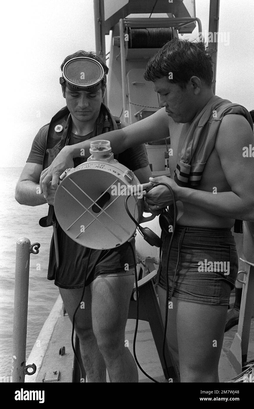 A Royal Thai navy diver assists Hull Maintenance Technician 1ST Class ...