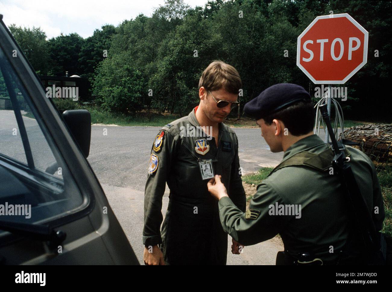 SRA Mike Lynott checks the line badge of 1LT Garth Anderson at a gate ...