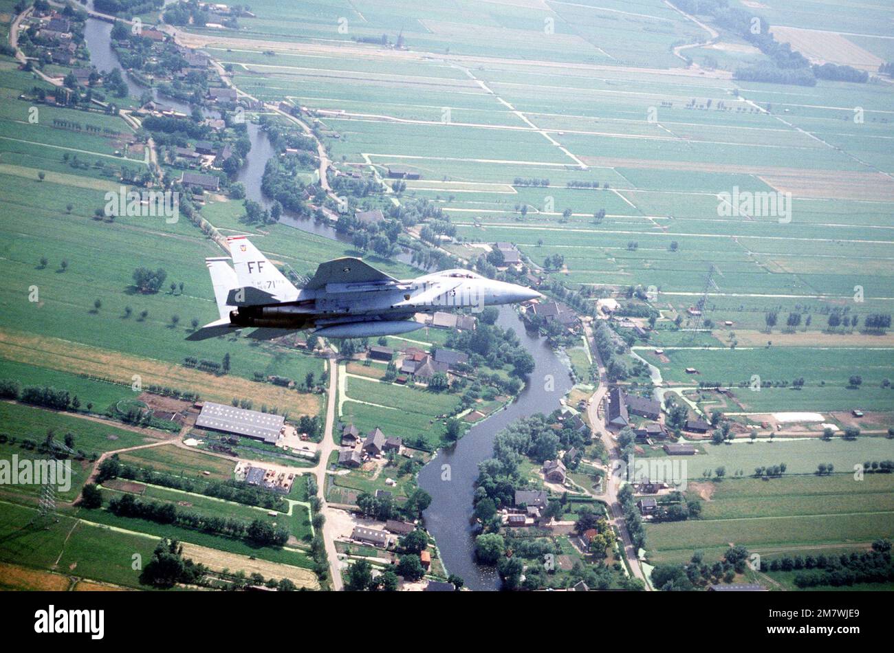 A right side view of an F-15A Eagle aircraft banking to the left during ...