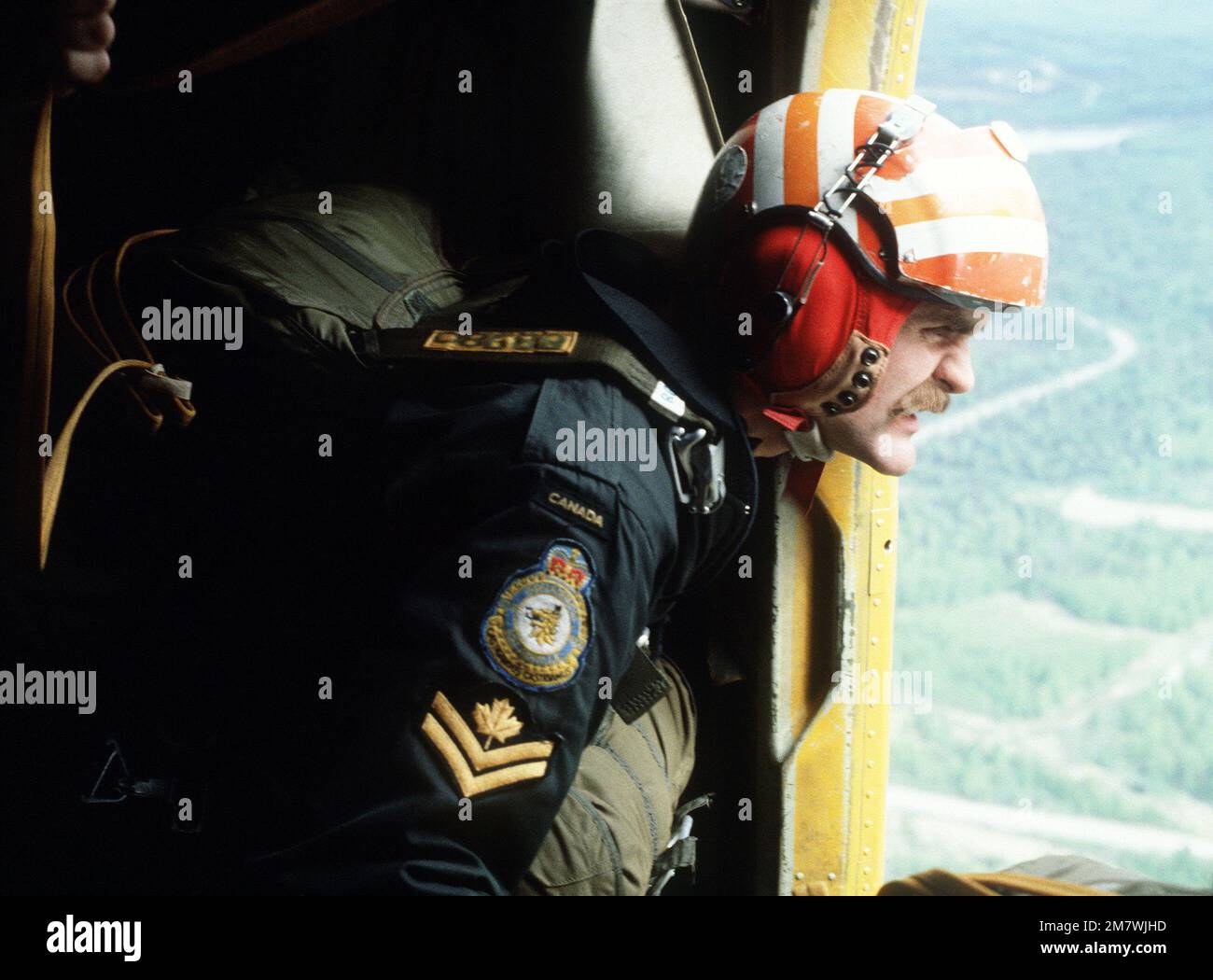 A Canadian search and rescue team members prepare for a jump from a DHC ...