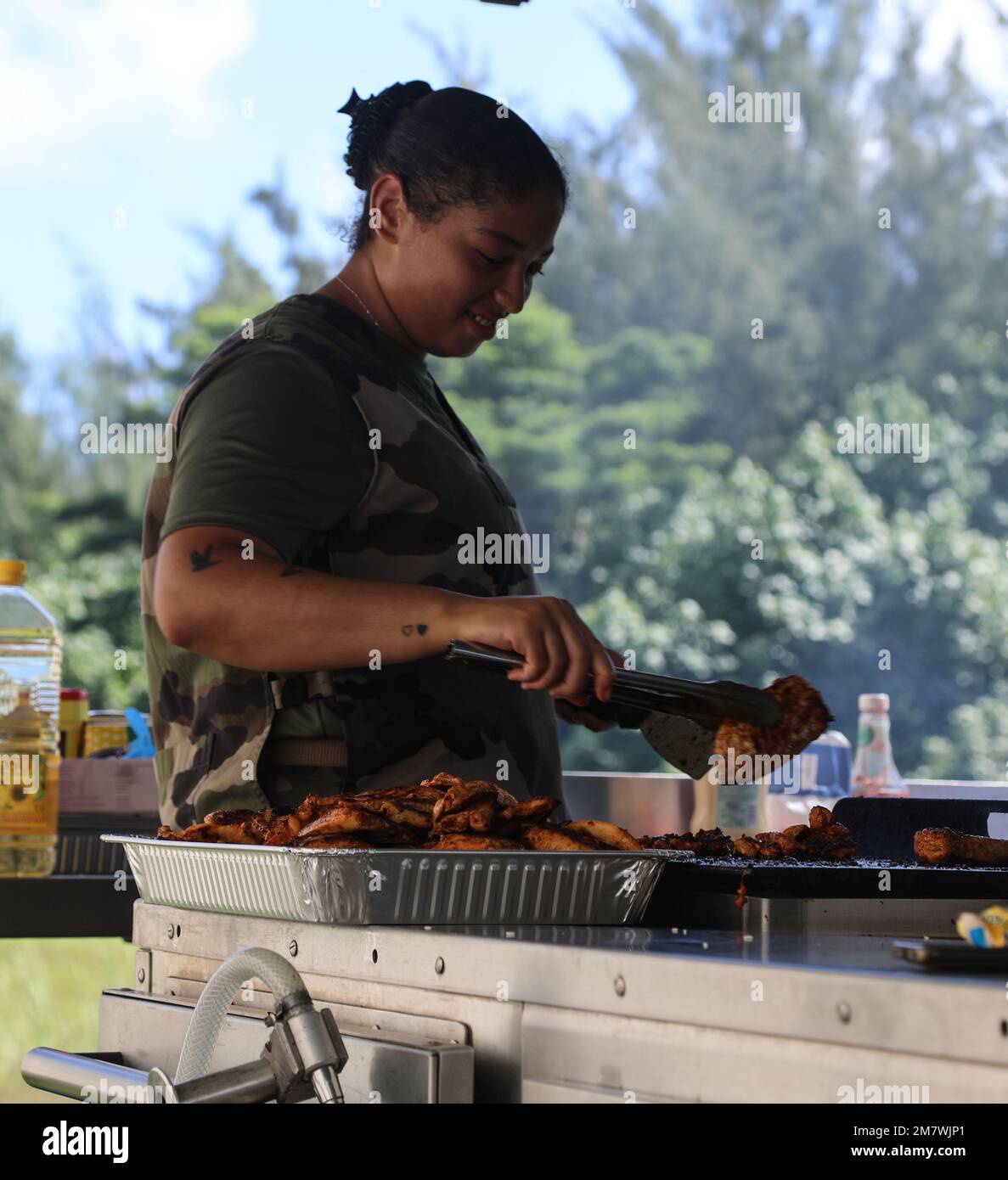 A French Polynesia soldier prepares chicken in a French tactical mobile ...