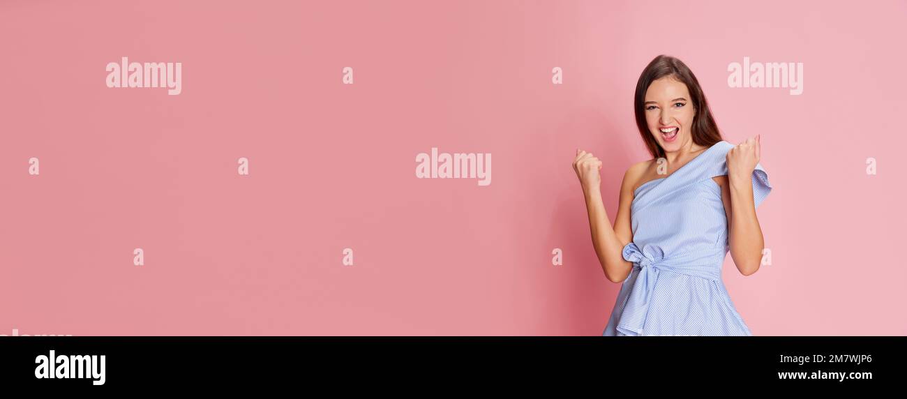 Success. Portrait of young emotive girl posing with winning emotions ...