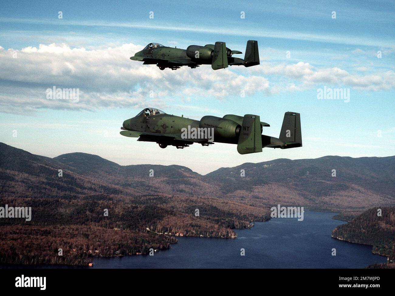 An air-to-air left side view of two A-10 Thunderbolt II aircraft from ...