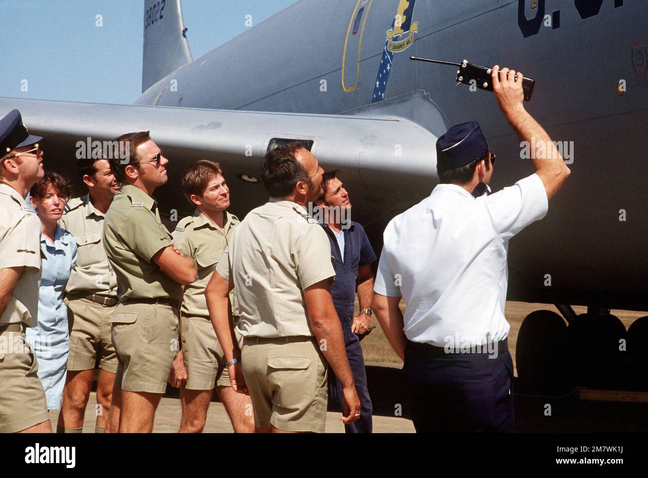 A KC-135 Stratotanker aircraft aircrew member explains the aircraft to ...