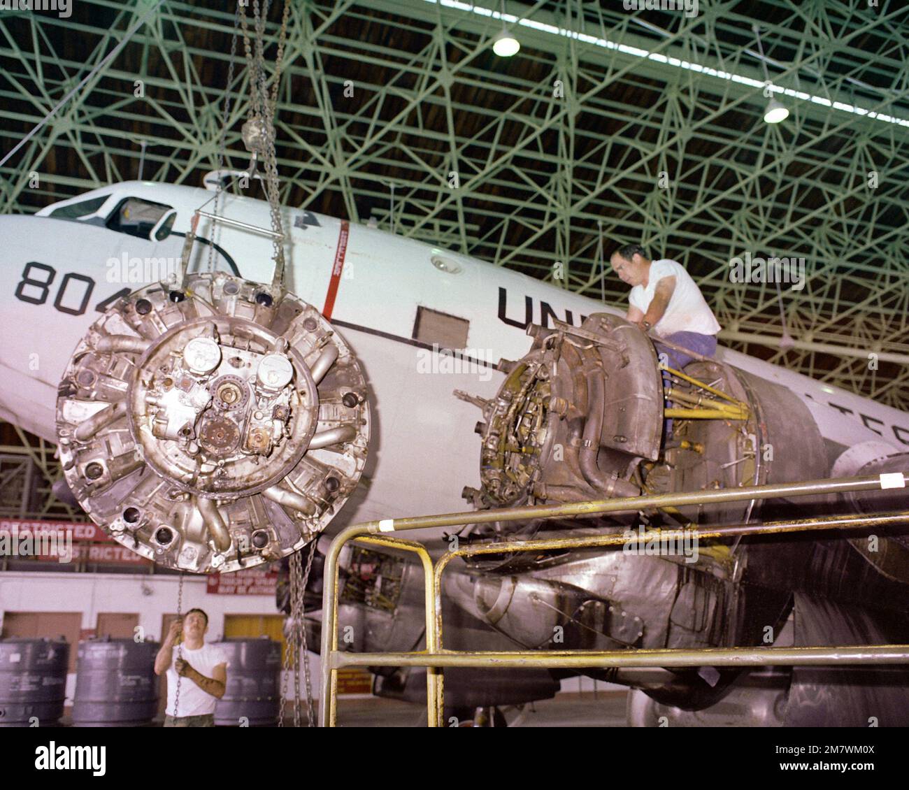 The engine of a C-117 aircraft is separated from the wing prior to ...