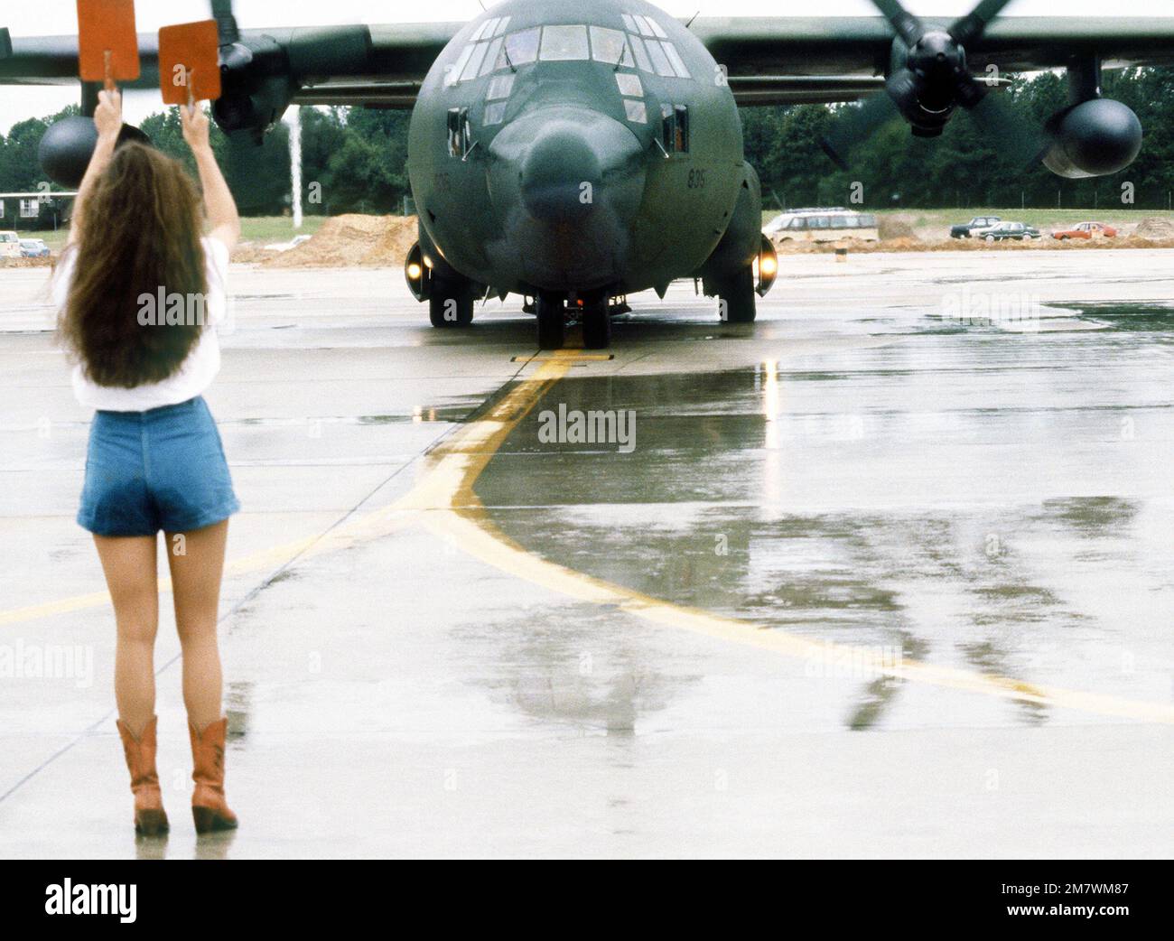 A Volant Rodeo '82 team member marshals an arriving C-130 Hercules ...