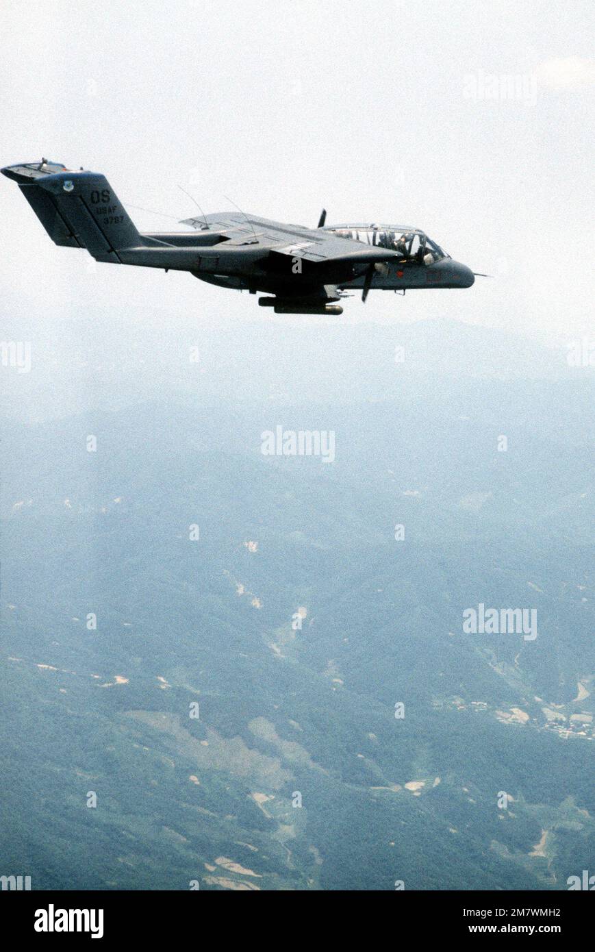 An air-to-air right side view of an OV-10A Bronco aircraft banking to ...