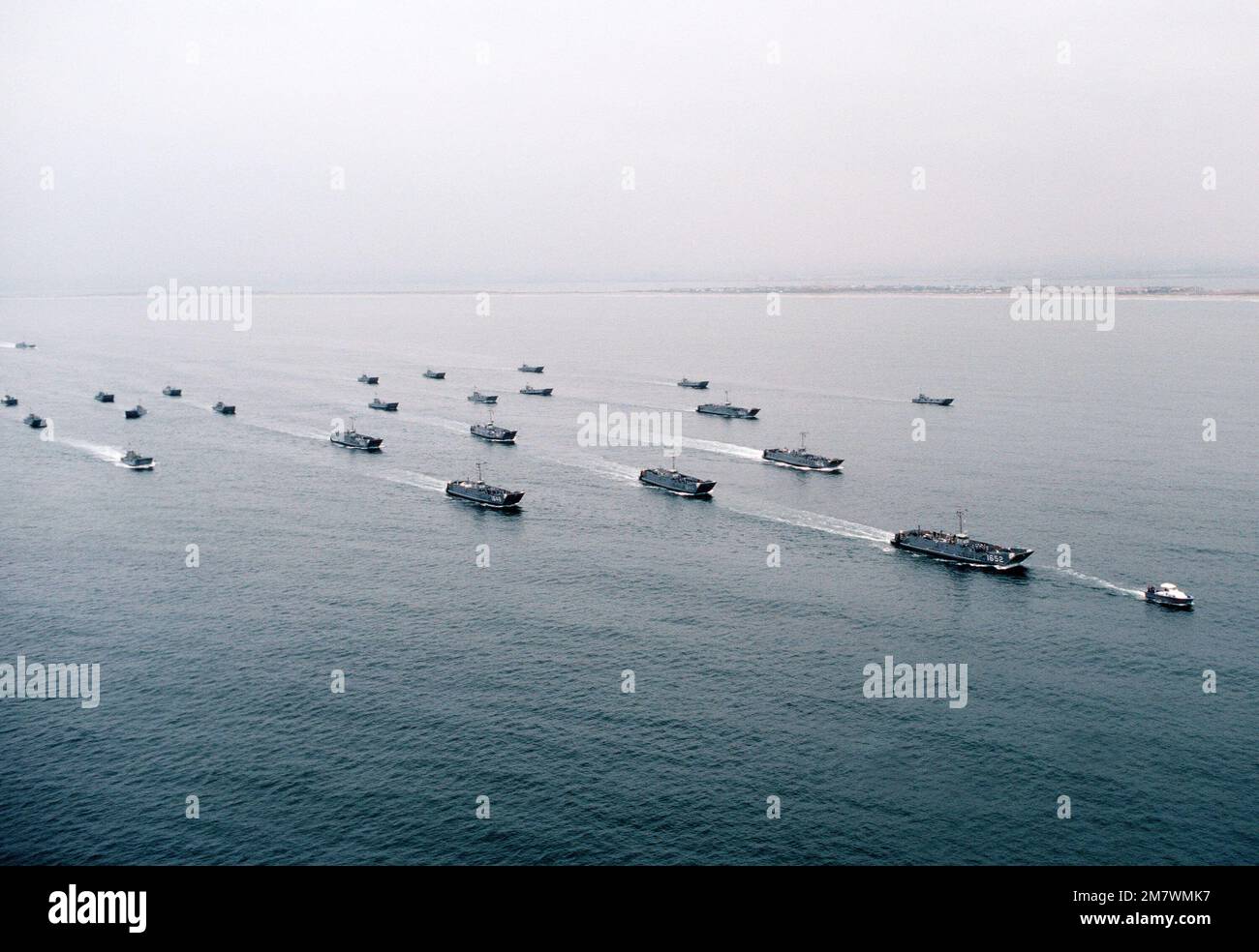 An aerial starboard bow view of utility and mechanized landing craft ...