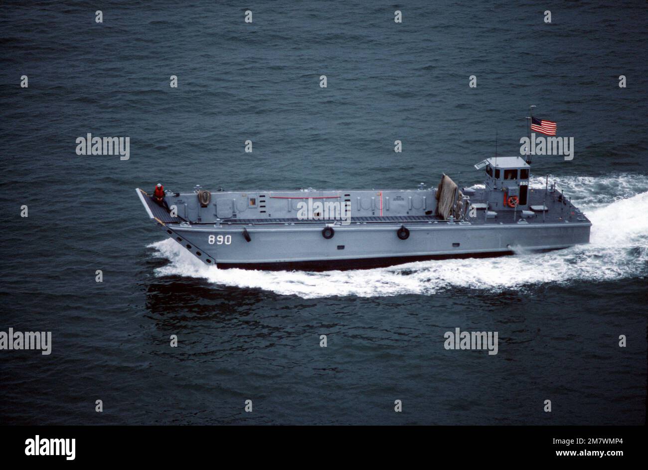 An aerial port beam view of the mechanized landing craft (LCM-890 ...