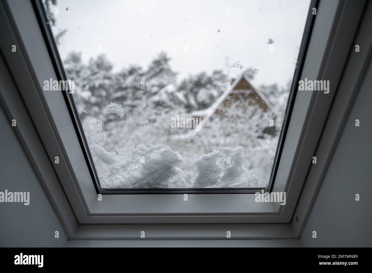 Window on roof covered by snow. View to neighbour's house Stock Photo ...