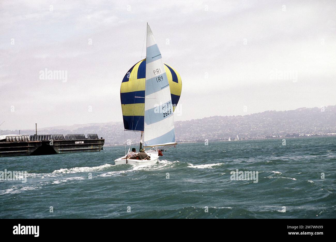 A sail boat, with spinnaker billowing, takes part in the Treasure ...