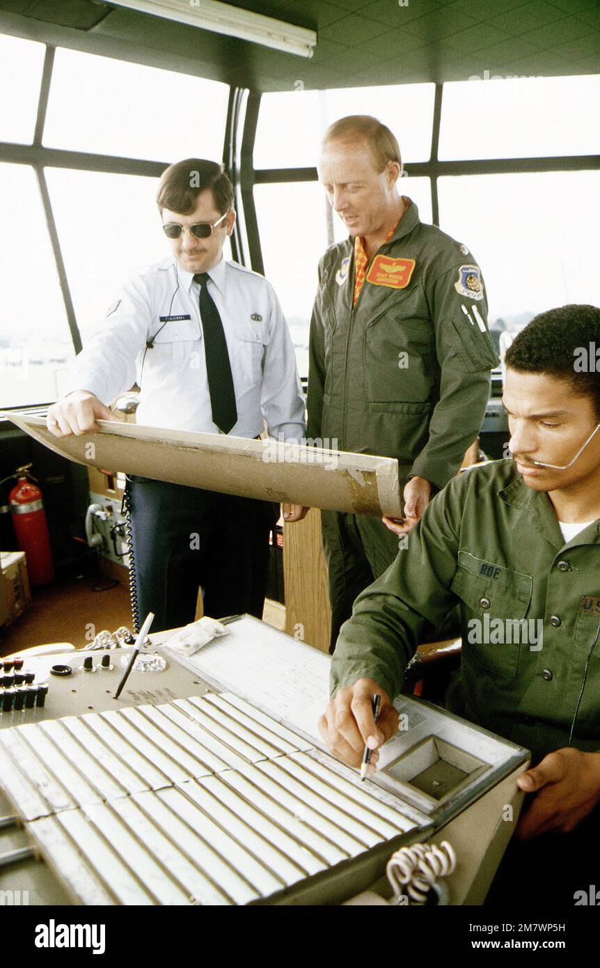 AMN Herbert W. Roe (foreground) takes care of aircraft flight data ...