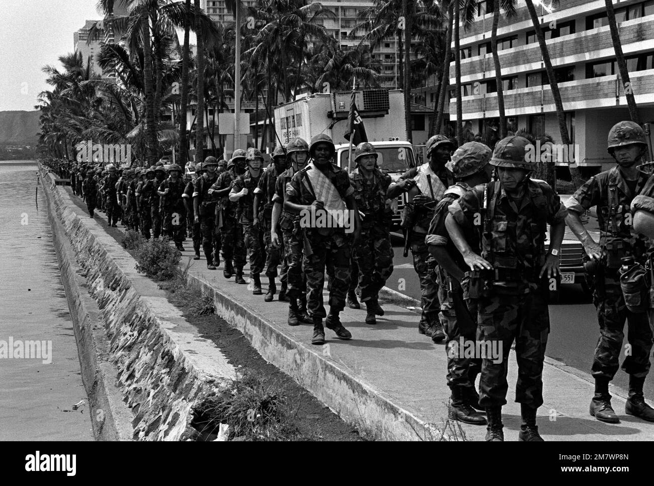 Members of Co. B, 1ST Bn., 35th Inf., 25th Inf. Div., pass alongside ...