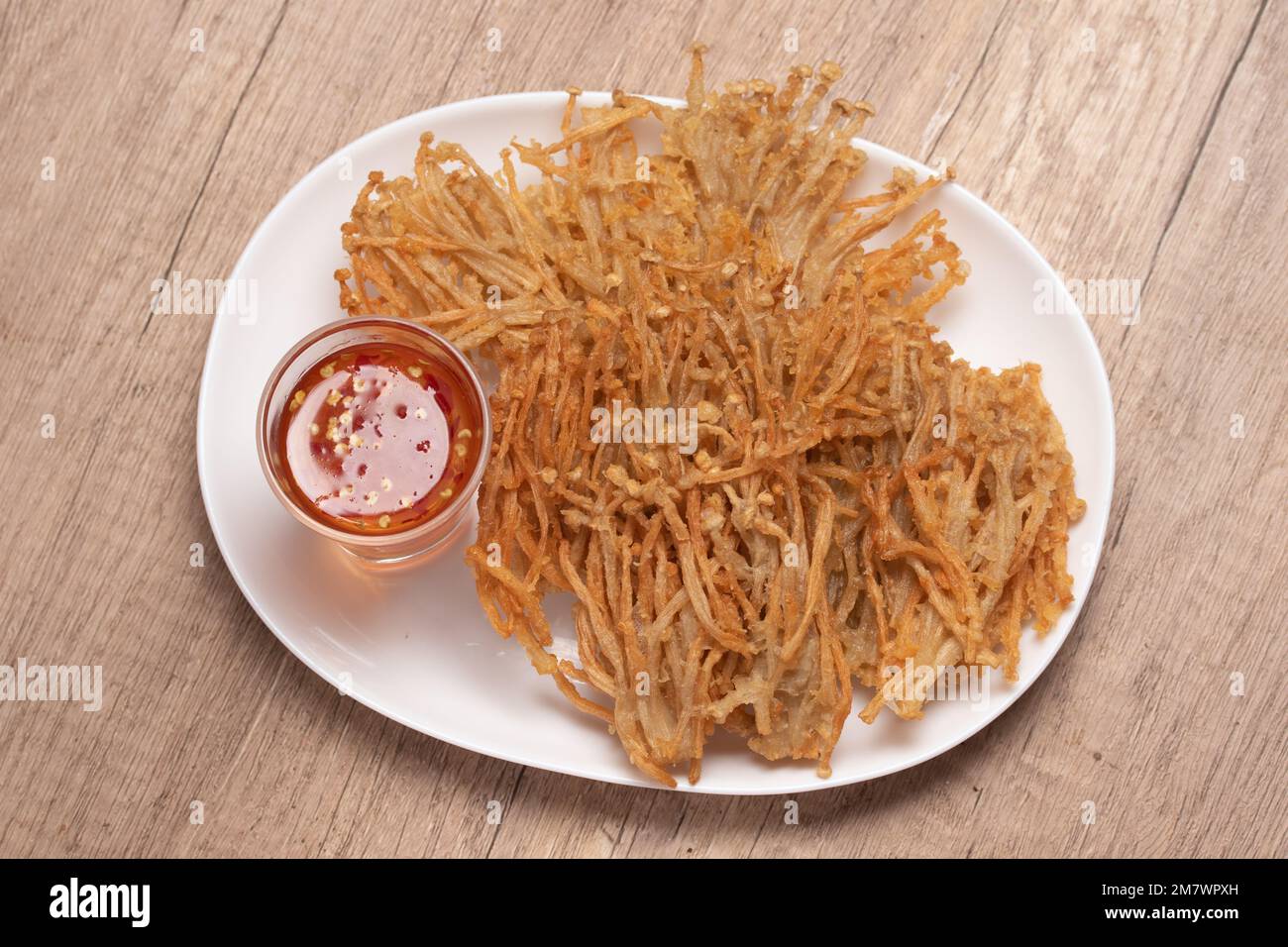 Deep-fried golden needle mushrooms with sweet and spicy sauce Stock ...