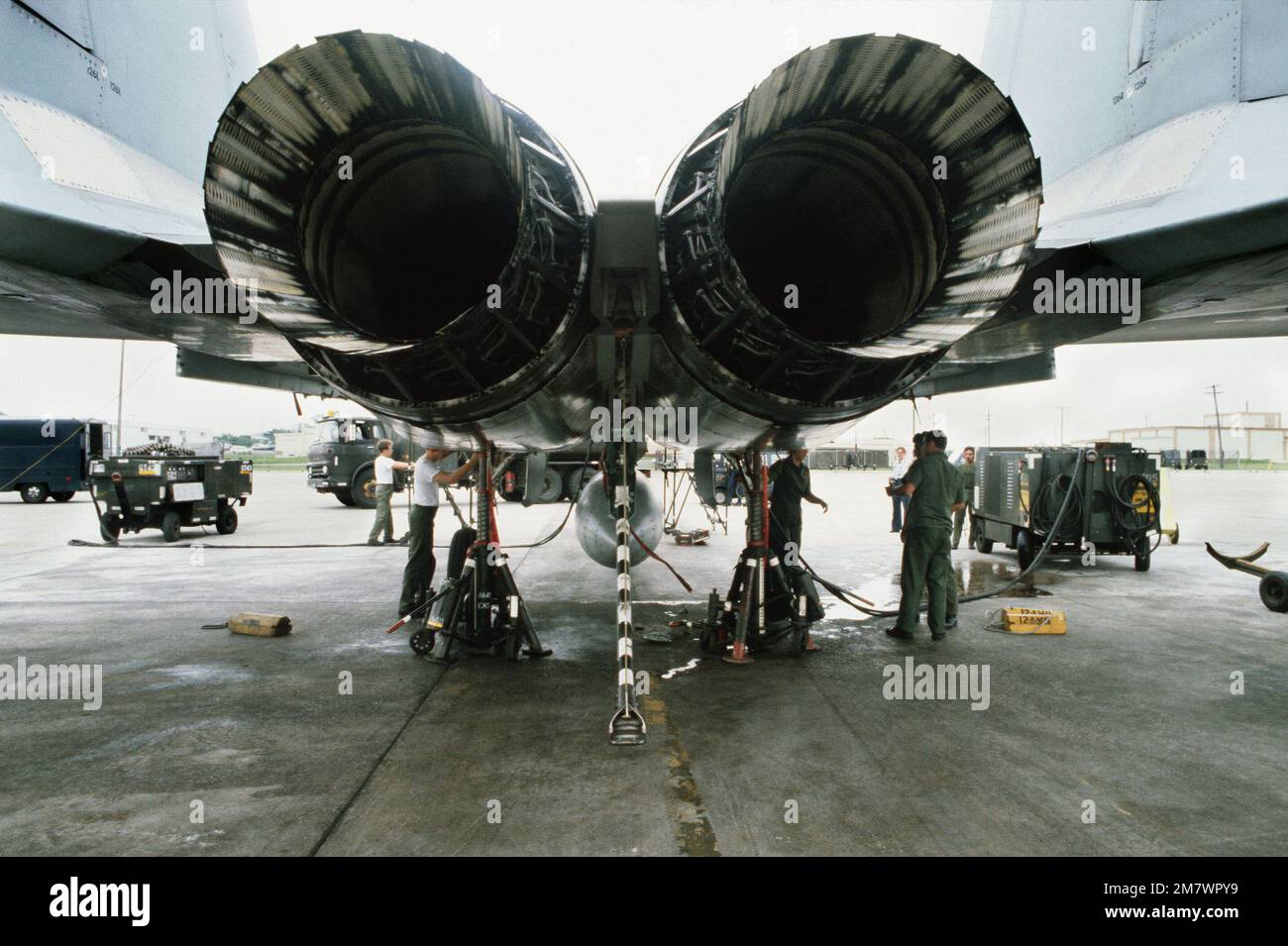 Ground crewmen check the landing gear of an F-15D Eagle aircraft during ...
