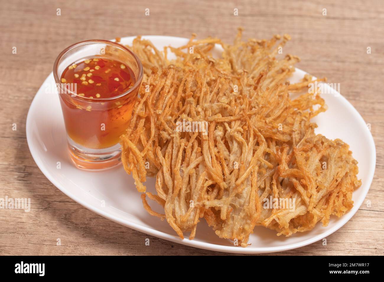 Deep-fried golden needle mushrooms with sweet and spicy sauce Stock ...