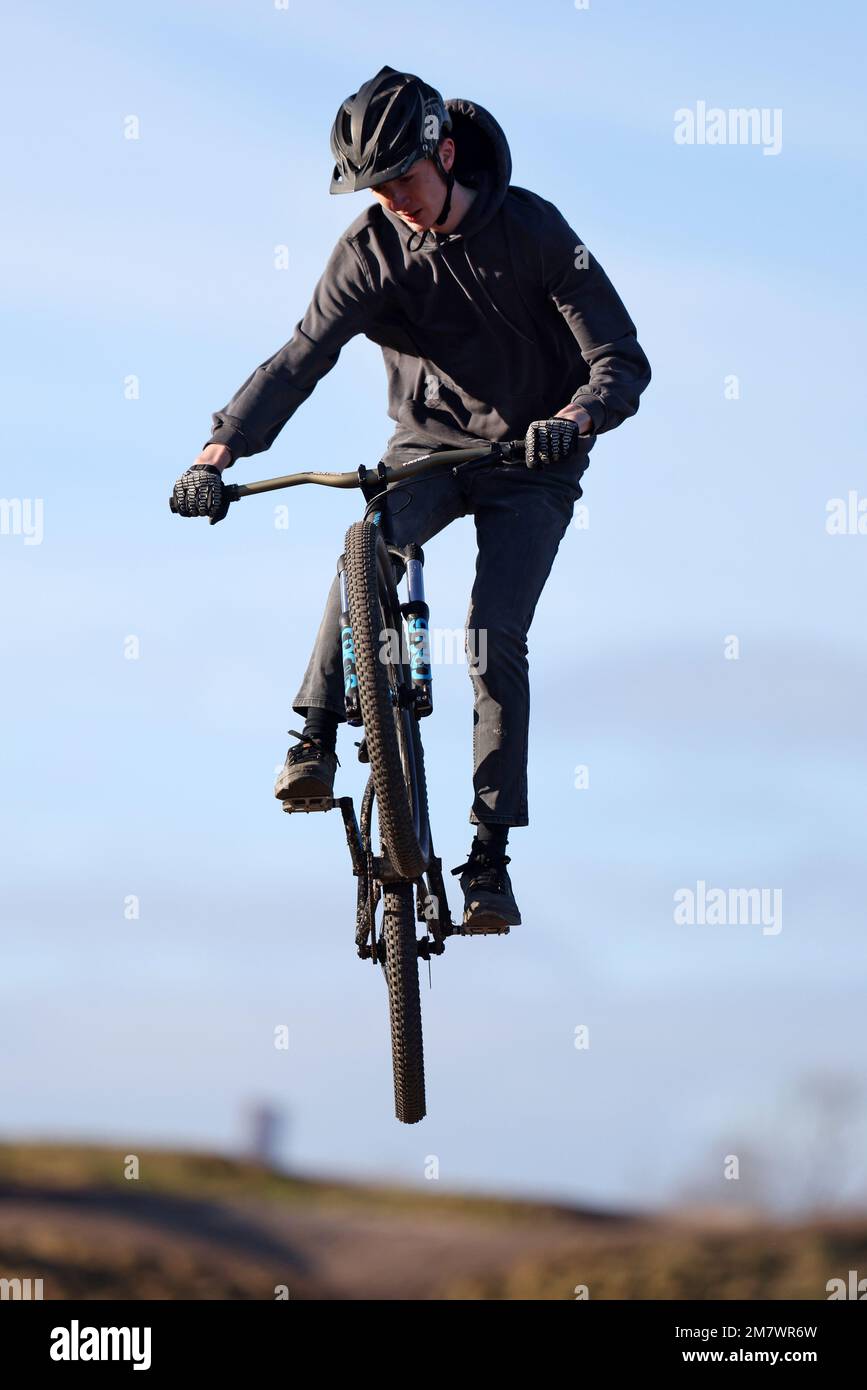 People ride and jump their mountain bikes at a BMX and pump track in ...