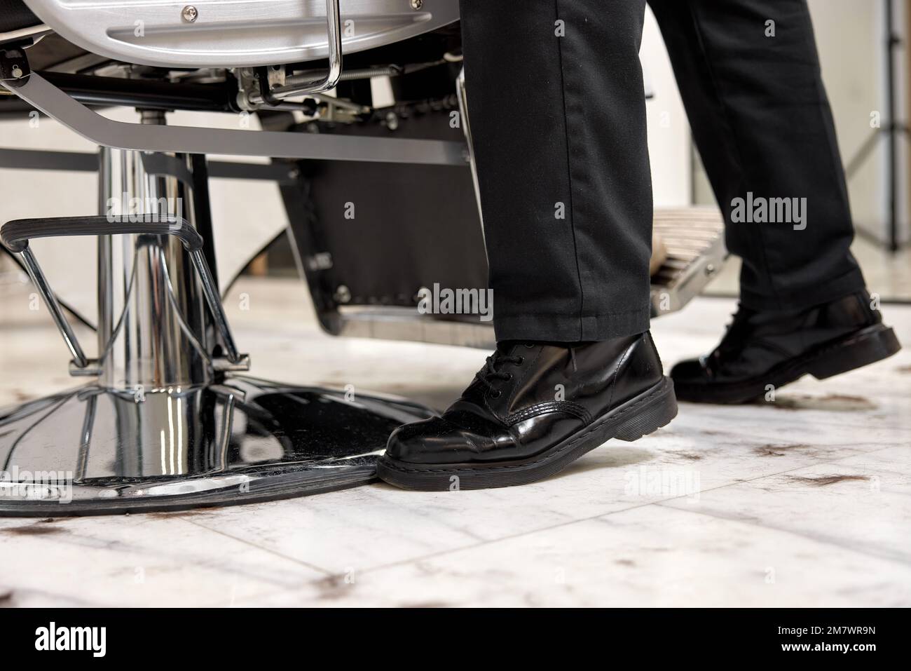 legs of barber in black leather shoes in barbershop Stock Photo - Alamy