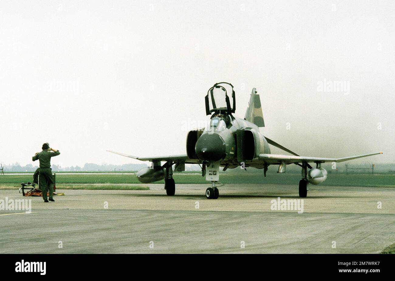 A ground crew member from the 183rd Tactical Fighter Group guides an F ...
