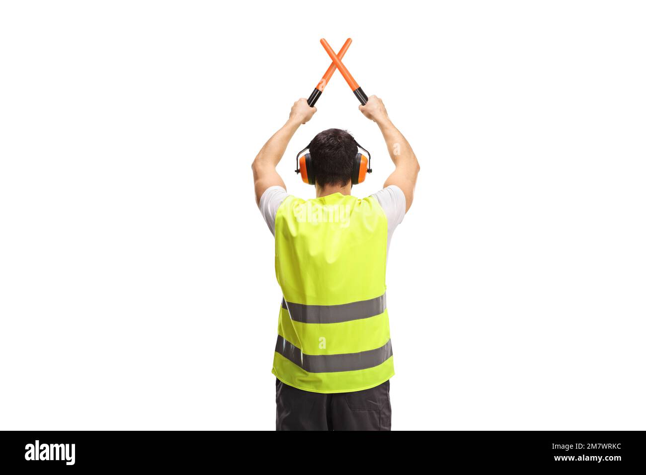 Rear view shot of an marshaller signalling with crossed wands isolated ...