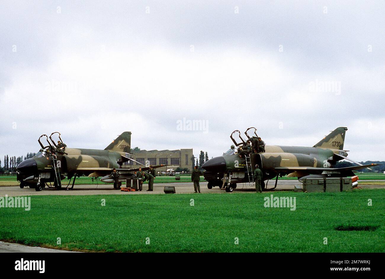 A left side view of two F-4D Phantom II aircraft as ground crew ...
