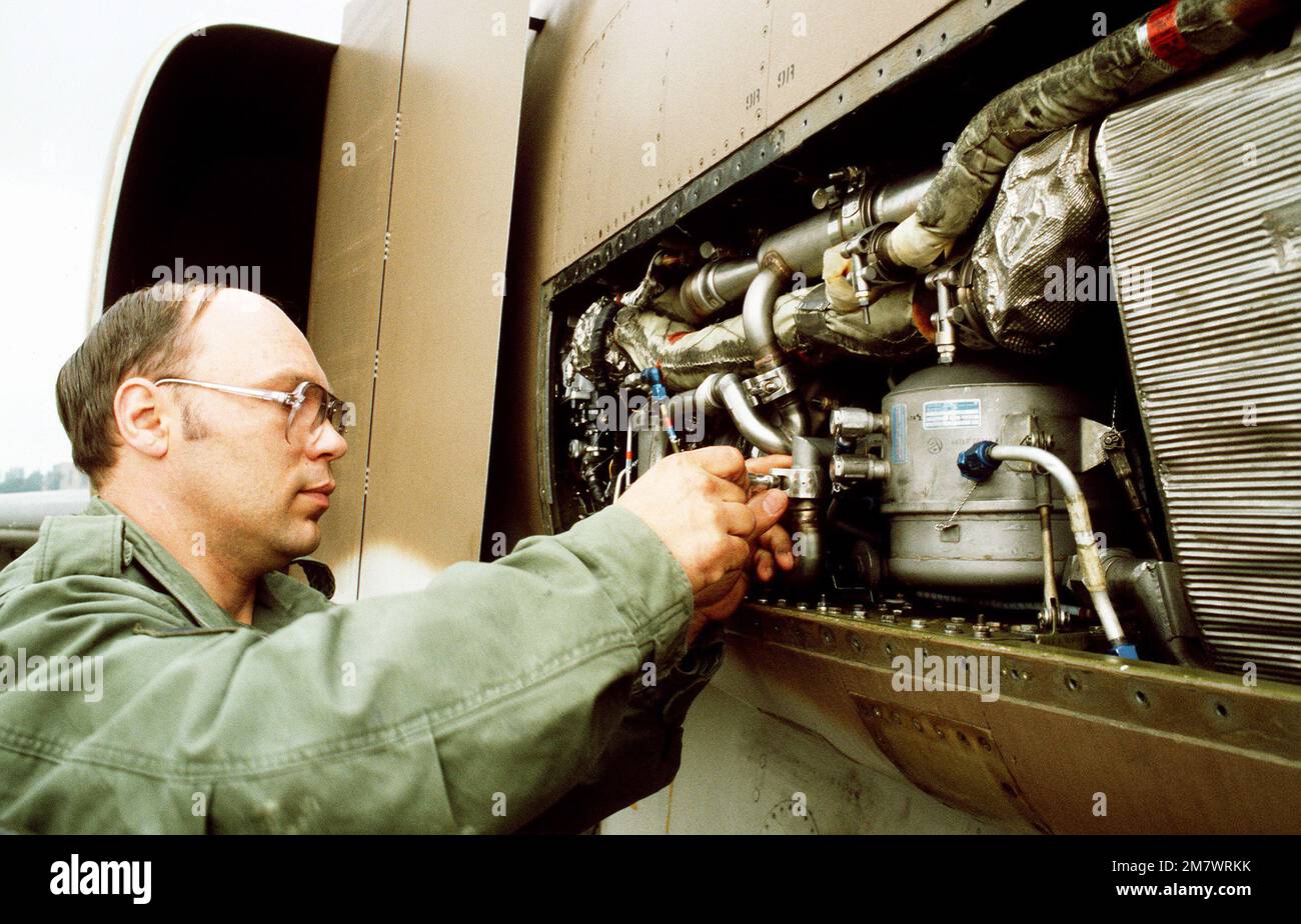 SSGT Roger Deichman performs maintenance on the air conditioning system ...