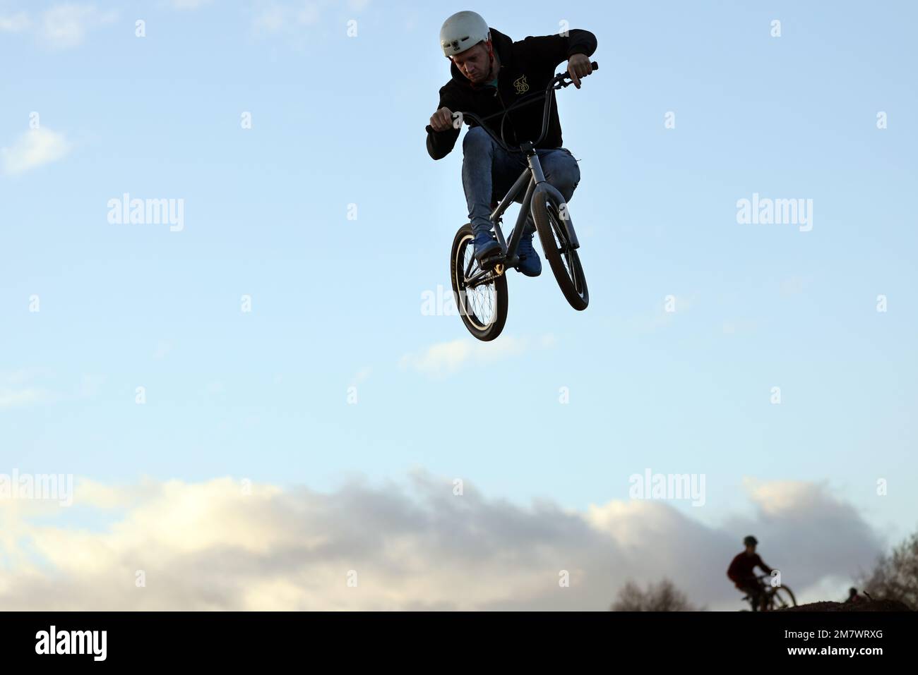 People ride and jump their mountain bikes at a BMX and pump track in ...