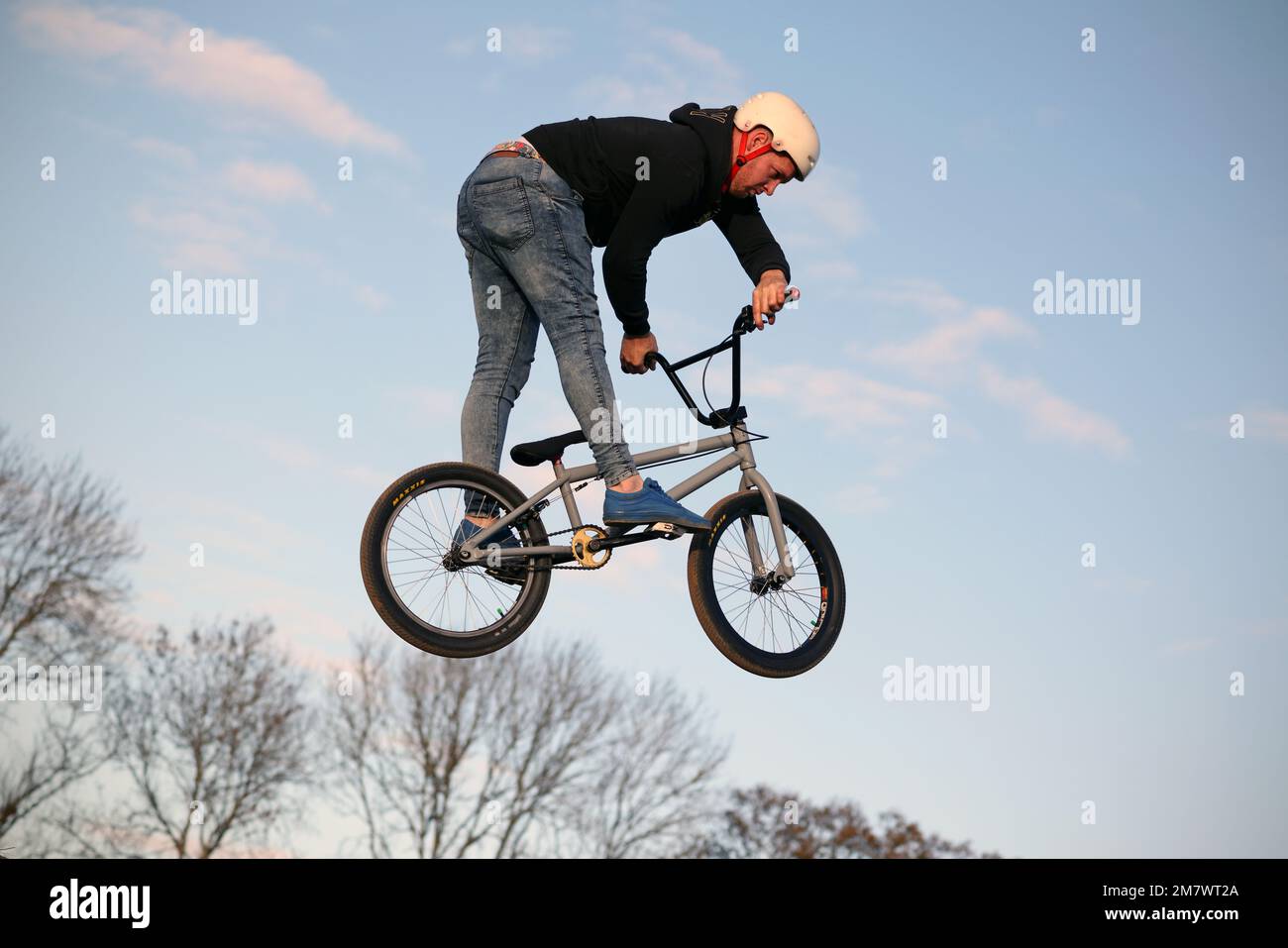 People ride and jump their mountain bikes at a BMX and pump track in ...