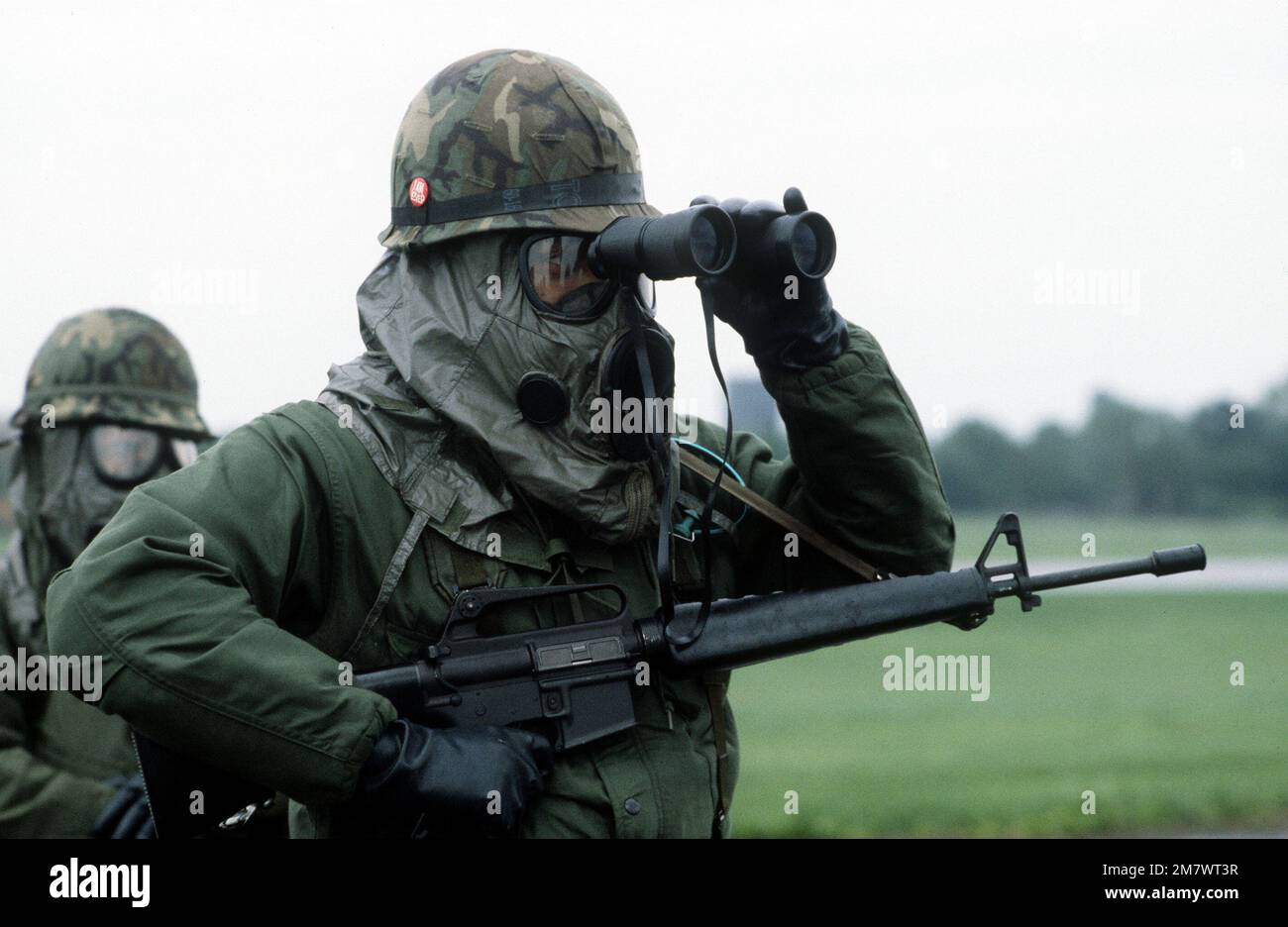 Airmen, armed with M-16 rifles, guard an F-4C Phantom II aircraft ...