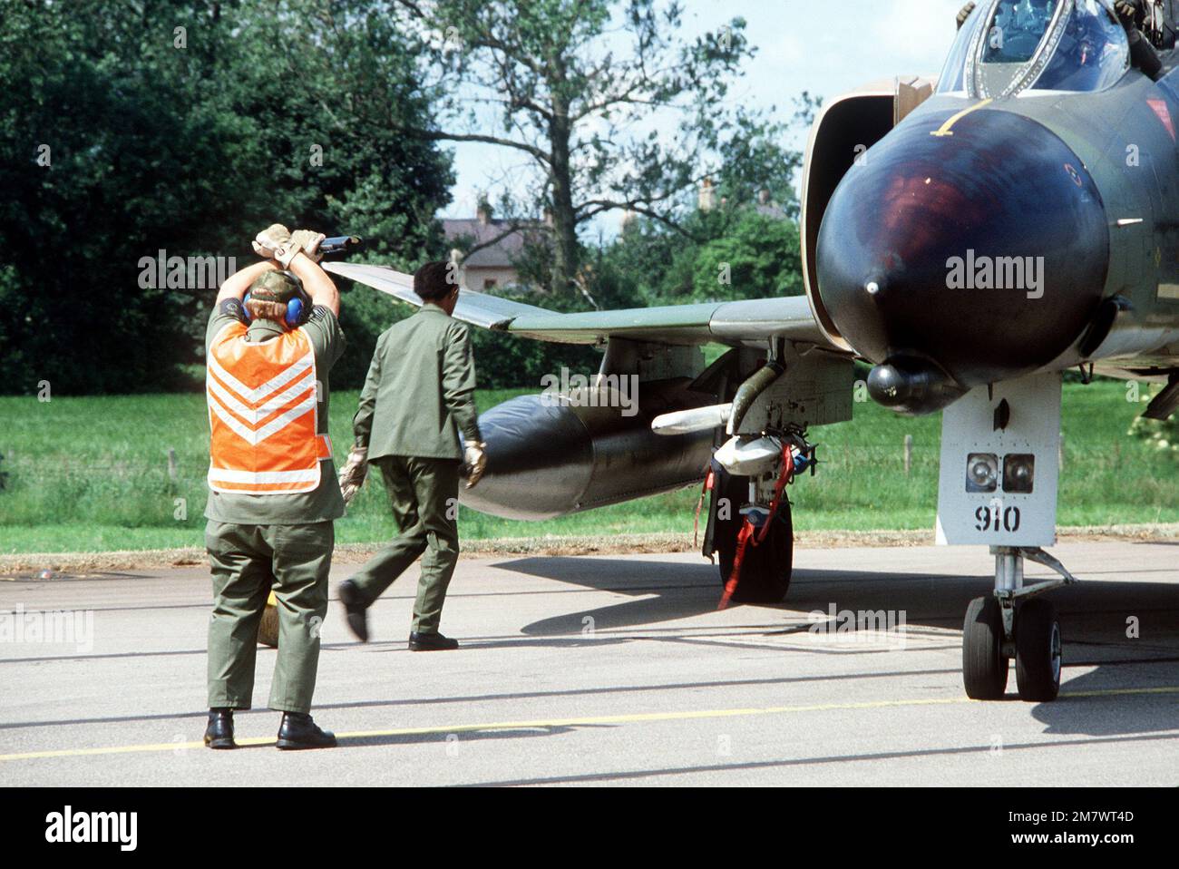 Ground crewmen make a final check on an F-4C Phantom II aircraft before ...