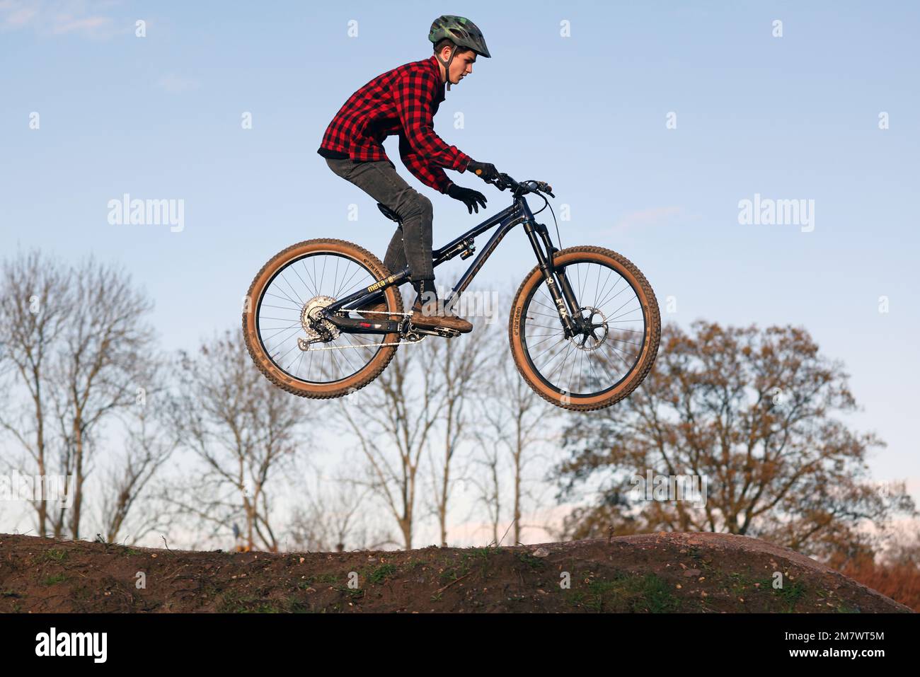 People ride and jump their mountain bikes at a BMX and pump track in ...