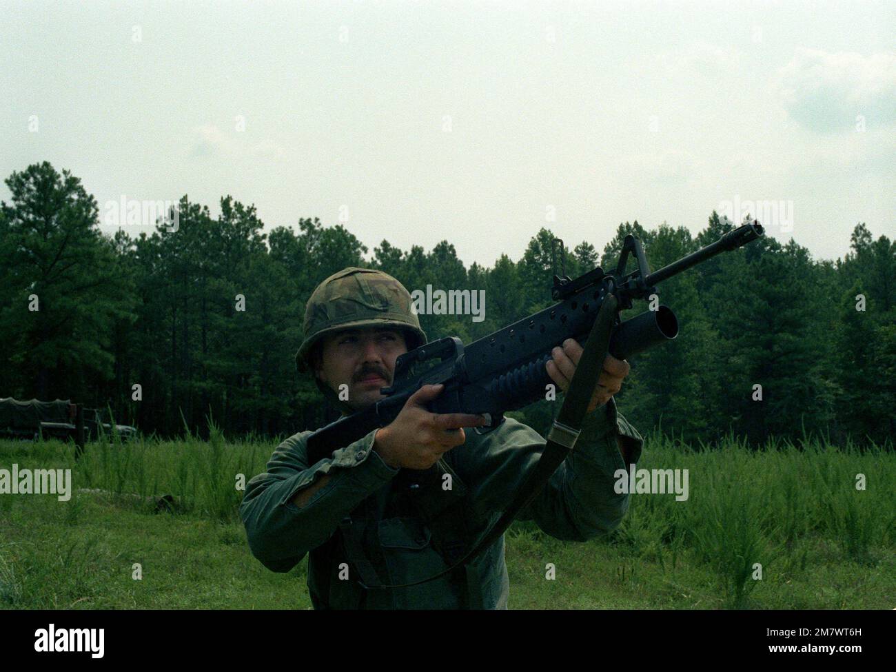 PFC Jeff Sullivan provides fire cover for other team members with an M ...