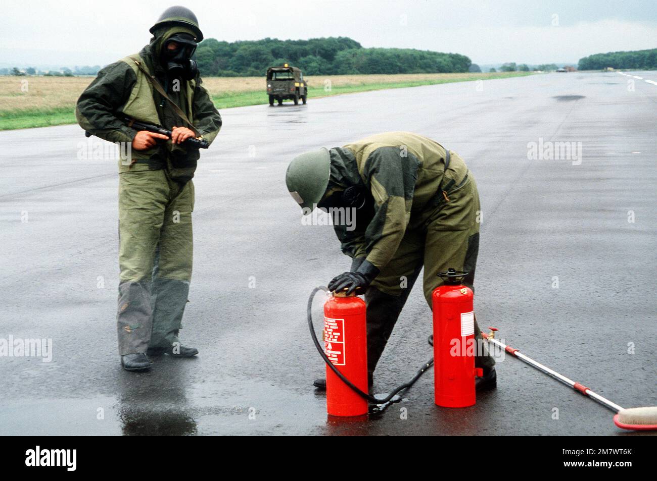 British Royal Air Force members prepare to decontaminate an F-C Phantom ...