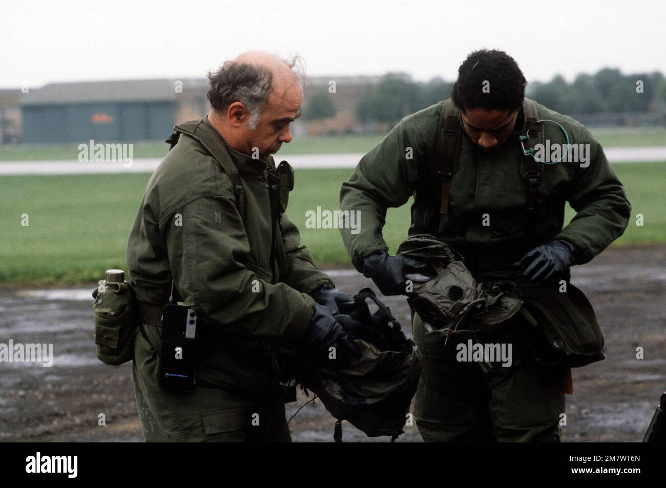 Airmen don their masks during chemical warfare training, part of ...