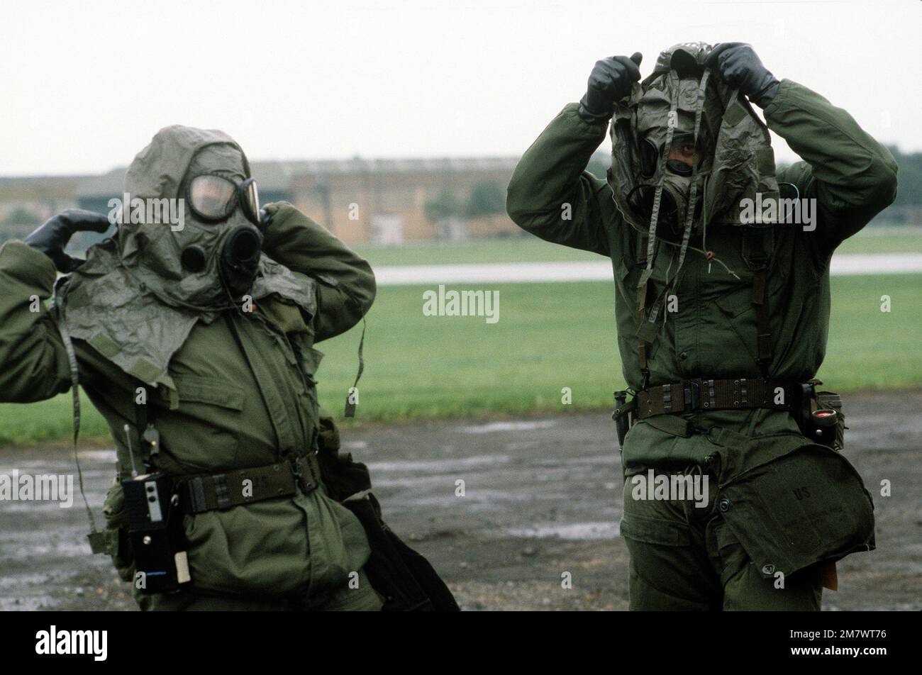 Airmen don their masks during chemical warfare training, part of ...