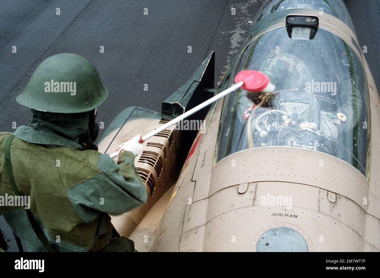 A British Royal Air Force member decontaminates an F-C Phantom II ...