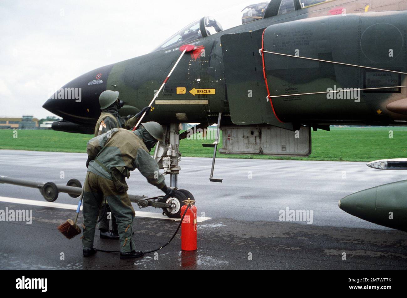 British Royal Air Force members decontaminate an F-C Phantom II ...