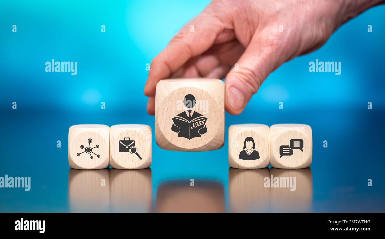 Wooden blocks with symbol of job search concept on blue background ...