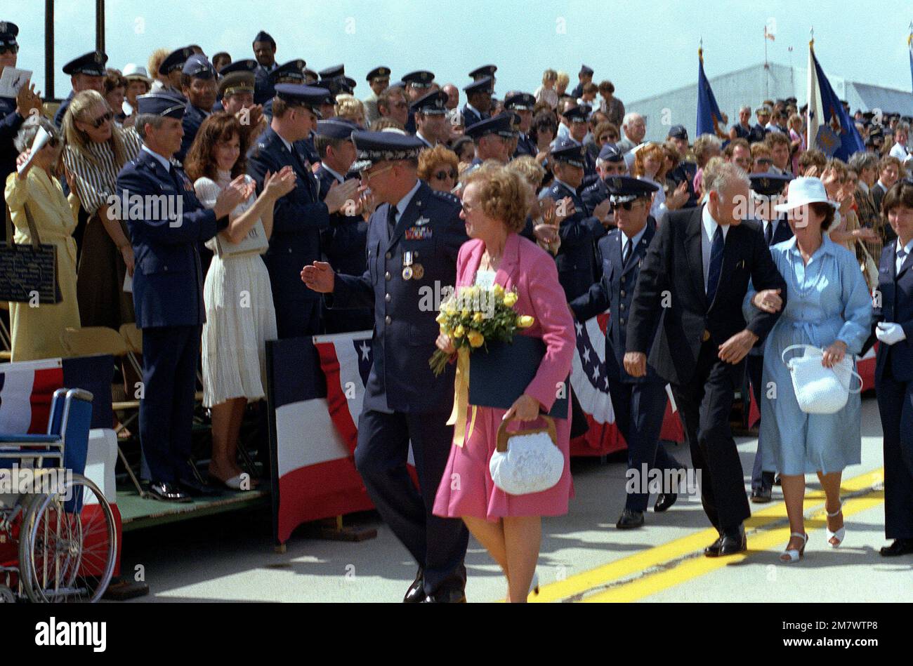GEN Lew Allen Jr. and his wife walk in front of clapping guests at the ...