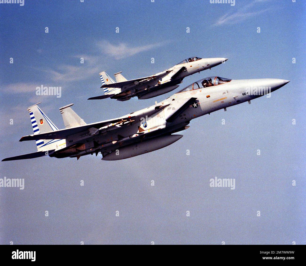 A right side air-to-air view of two F-15 Eagle aircraft. The aircraft ...