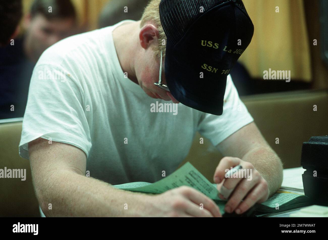 A crewman studies in the mess deck area aboard the Los Angeles class ...