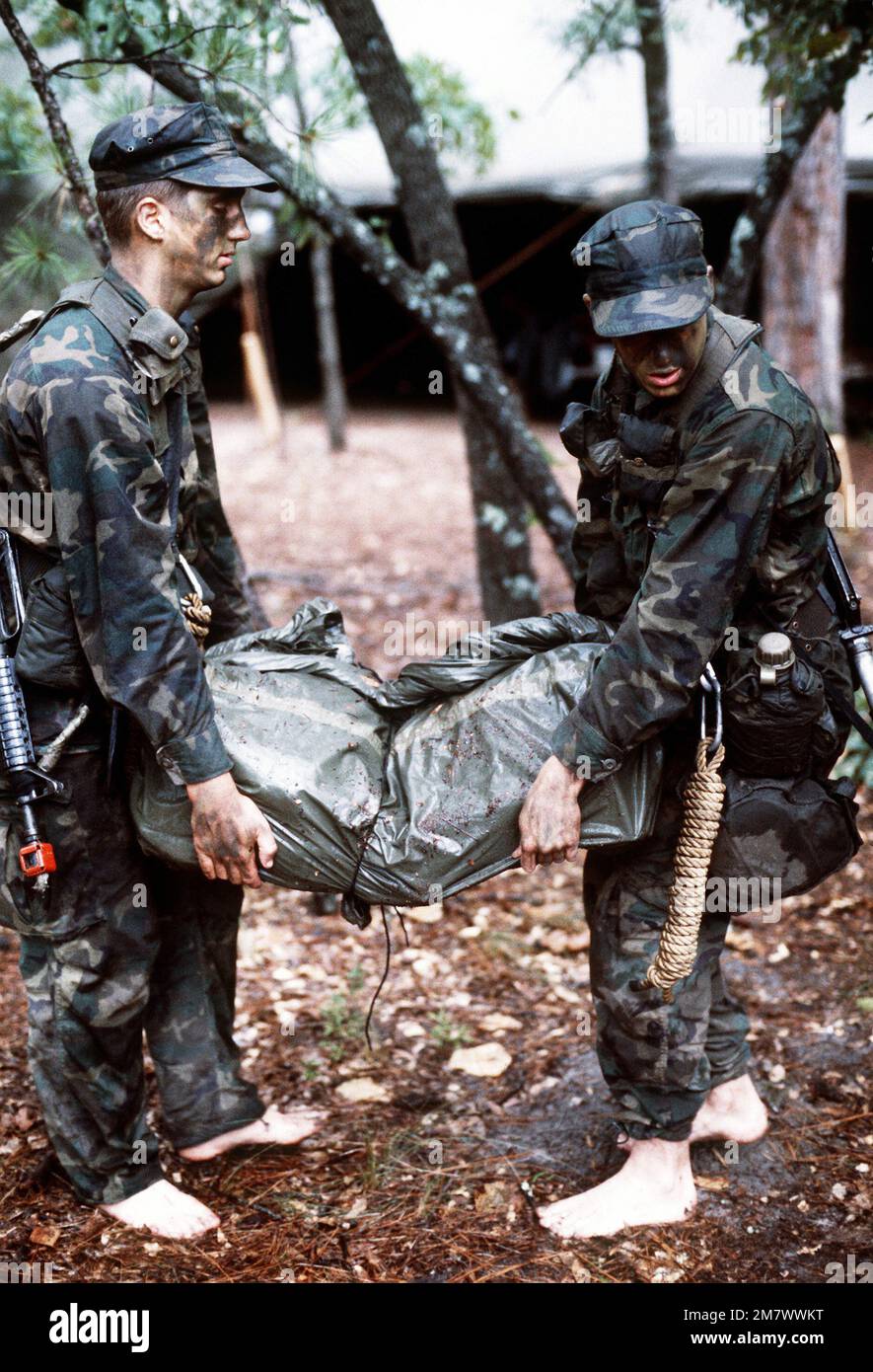 Combat Control School students, handling a pack of equipment, prepare ...