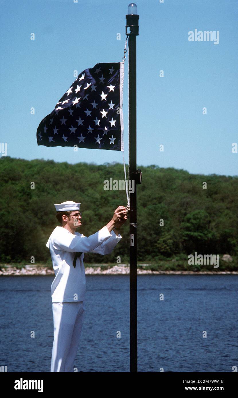 Colors are raised on board the nuclear-powered attack submarine USS BALTIMORE (SSN-704) during ...