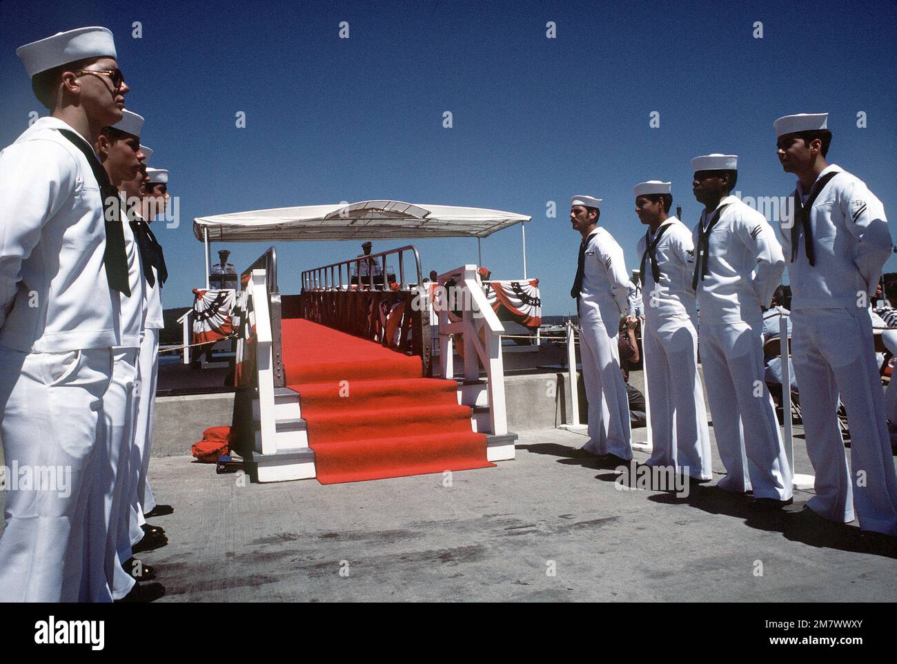 Crewmen stand at parade rest in front of the gangplank of the nuclear ...