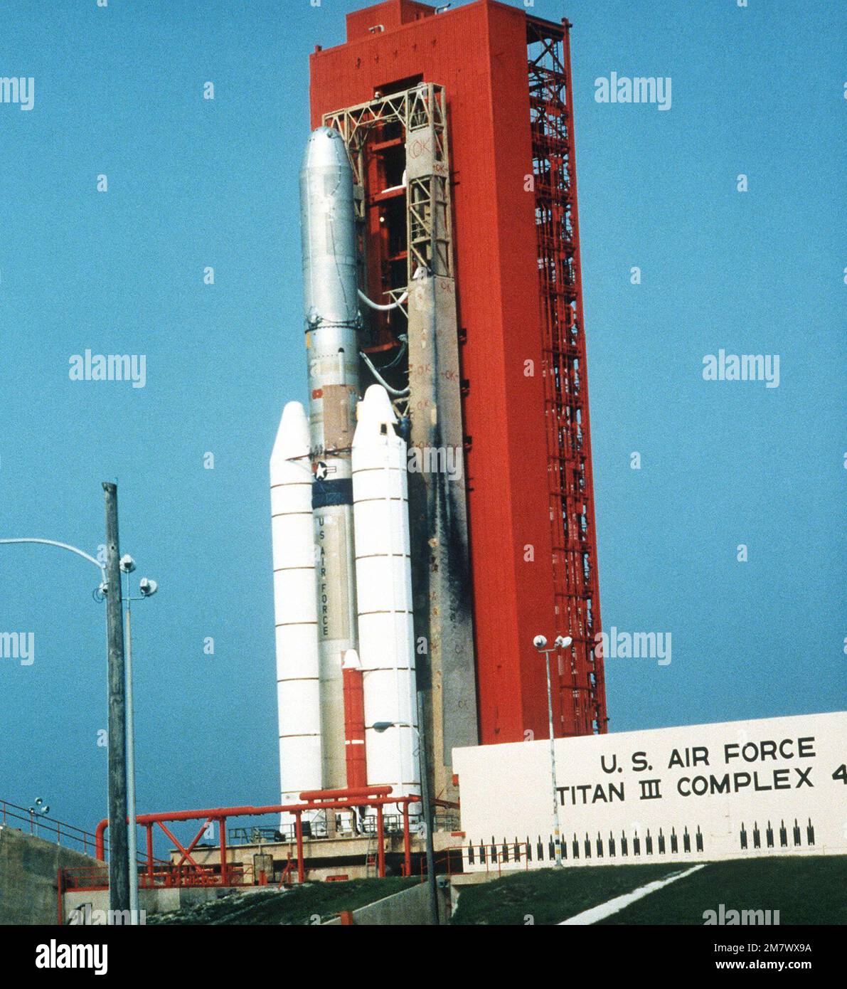 A Titan 34D launch vehicle in full configuration with the main service tower in park position ...