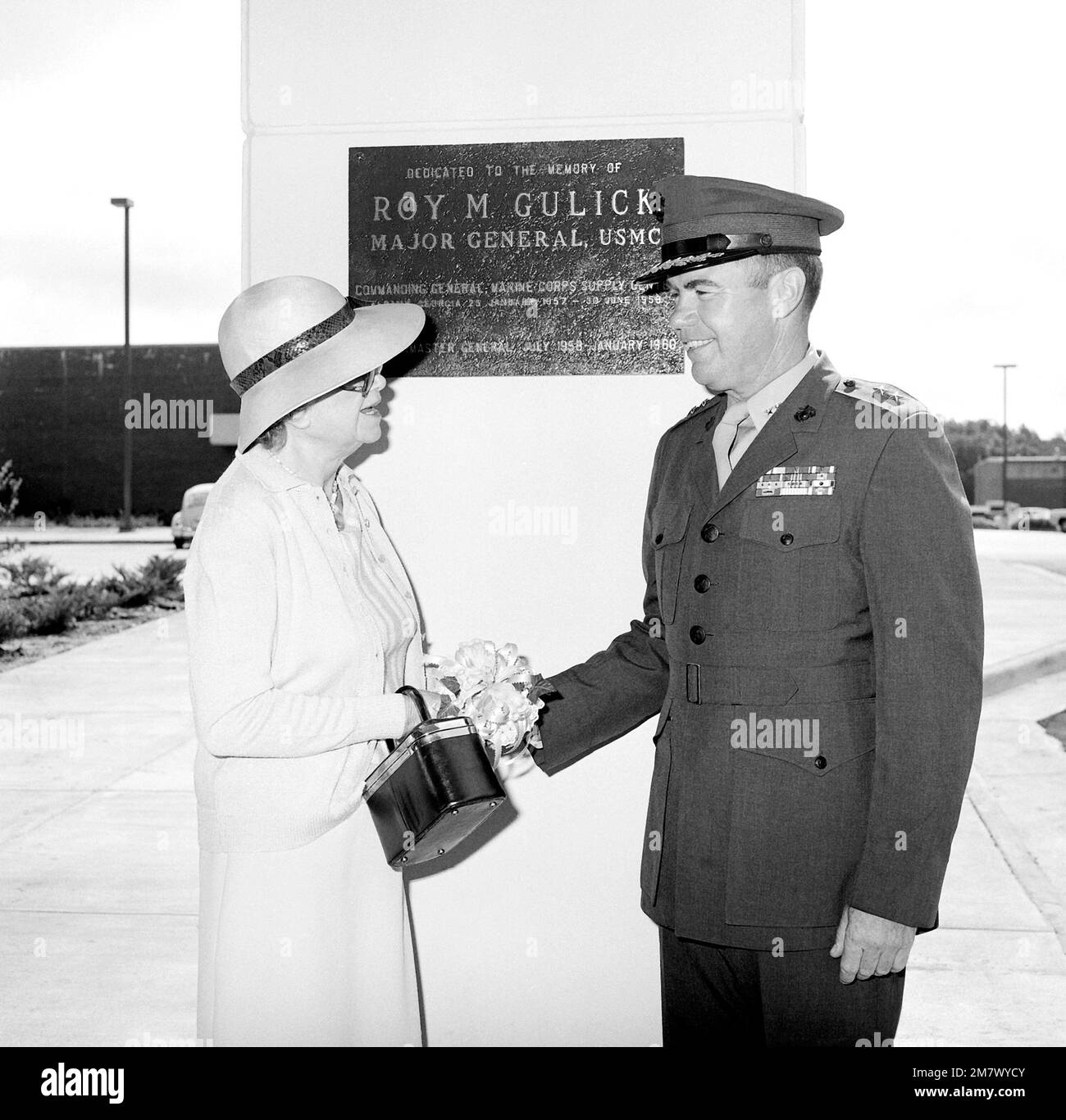 MGEN Lawrence F. Sullivan gives Mrs. Roy M. Gulick a bouquet of flowers ...