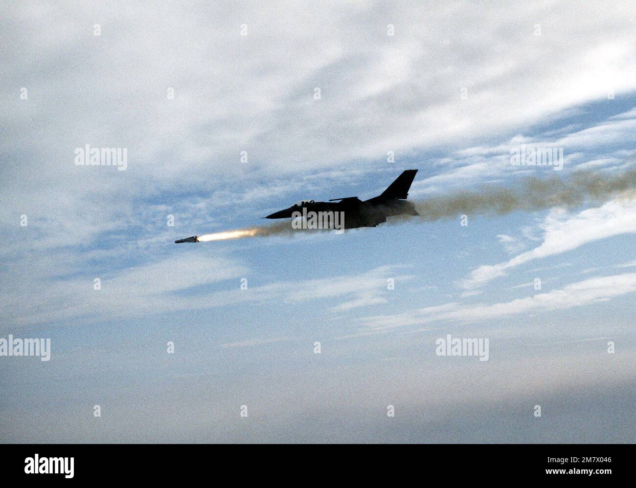 An air-to-air left side view of an F-16A Fighting Falcon aircraft from ...