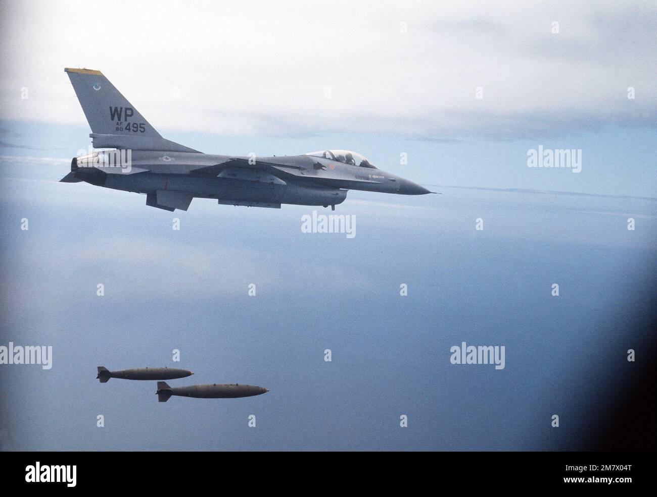 An air-to-air right side view of an F-16A Fighting Falcon aircraft from ...