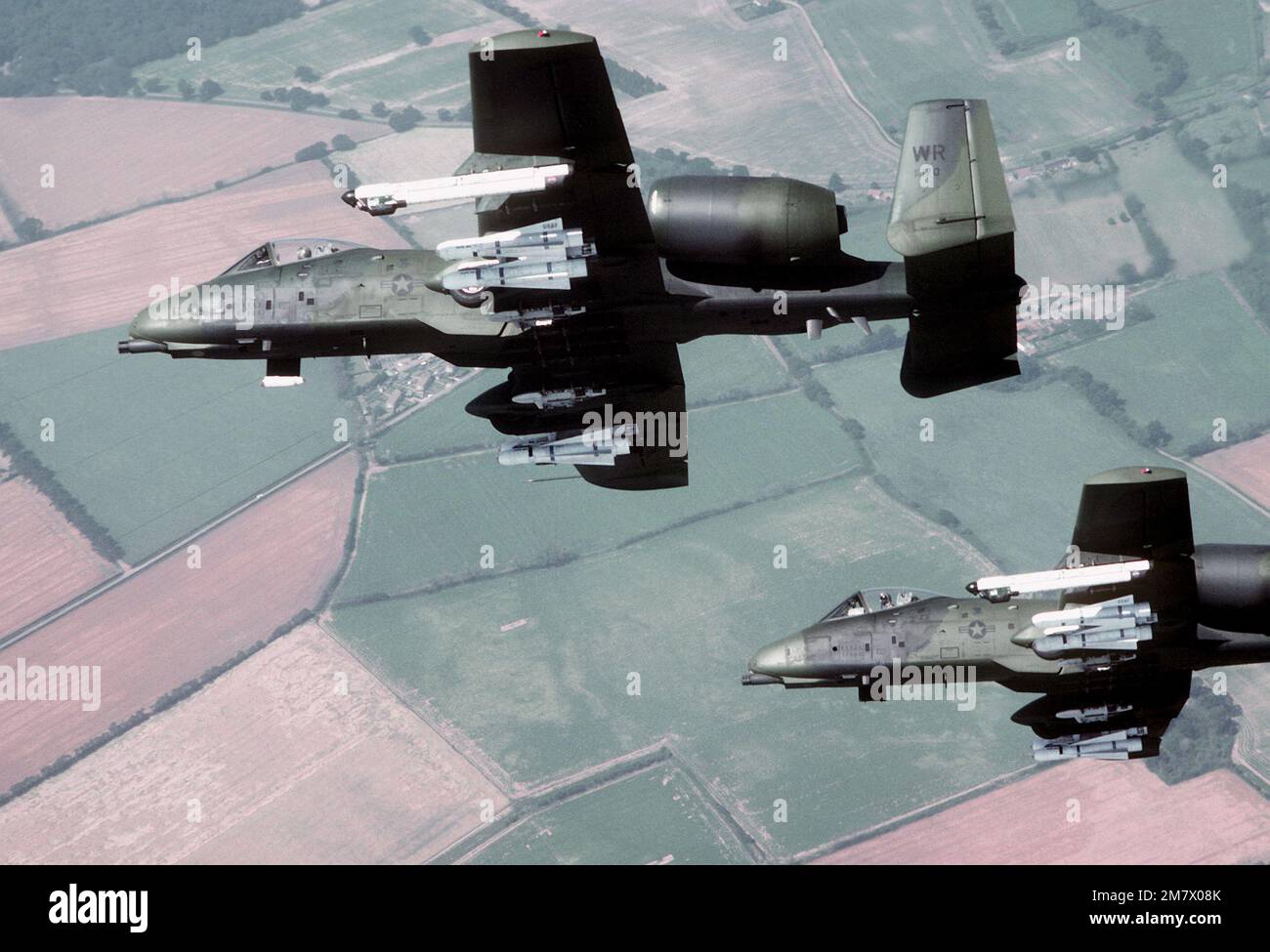 An air-to-air left underside view of two A-10 Thunderbolt II aircraft ...